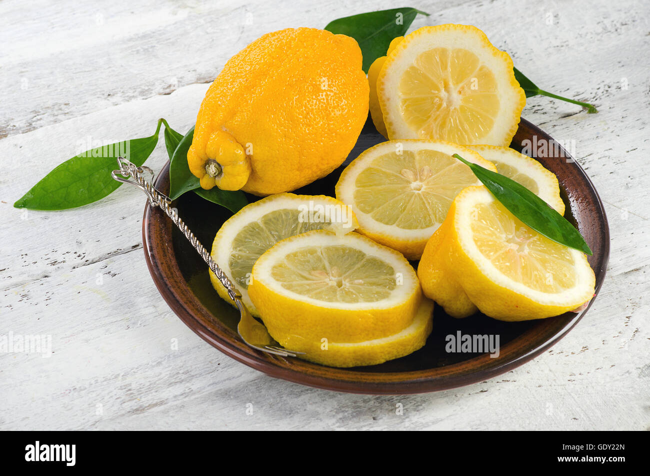 Lemons on plate. Healthy eating Stock Photo - Alamy