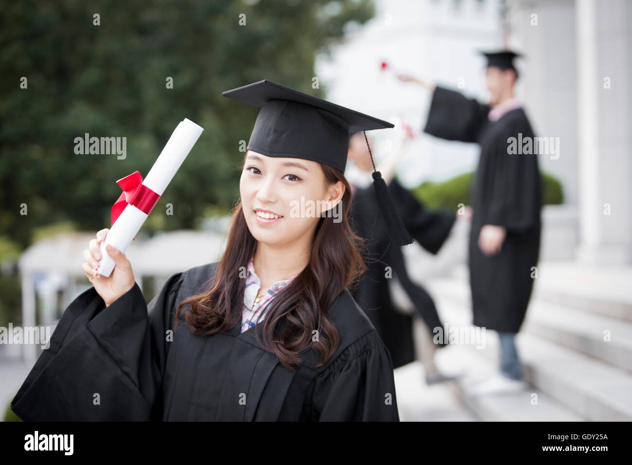 Smiling graduate holding diploma hi-res stock photography and images ...
