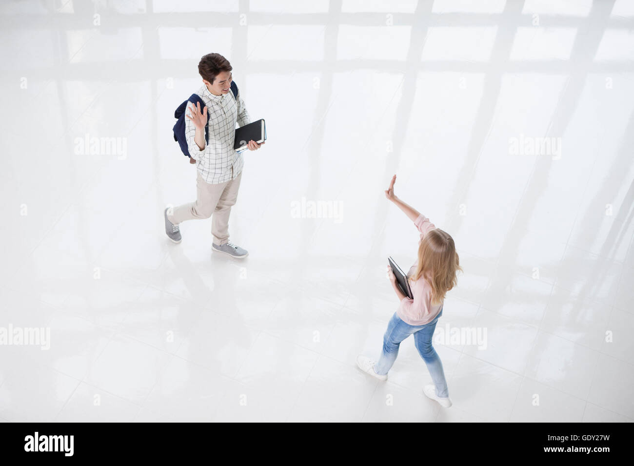 Two students waving each other hi-res stock photography and images - Alamy