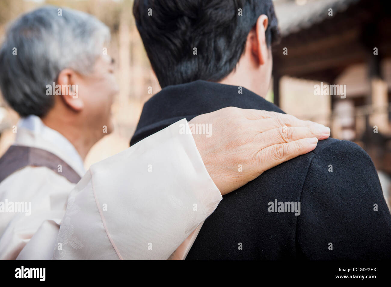 Portrait of old man placing his hand on young man's shoulder Stock ...