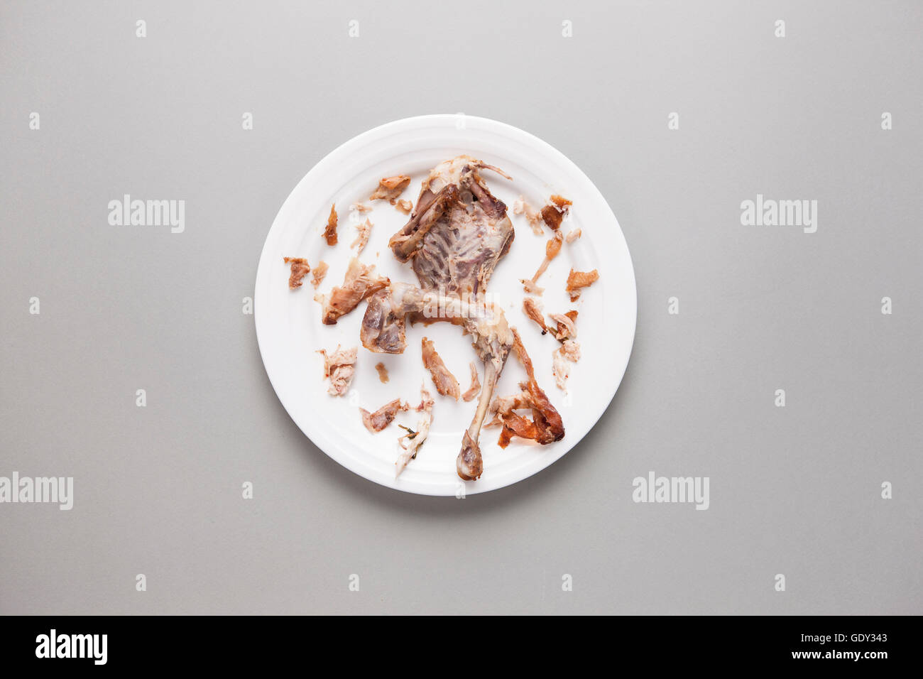 Chicken bones on plate Stock Photo - Alamy