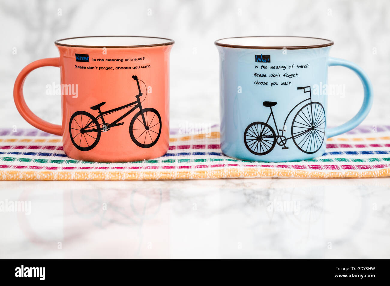 Colorful modern ceramic mugs with bicycle design on white marble ...