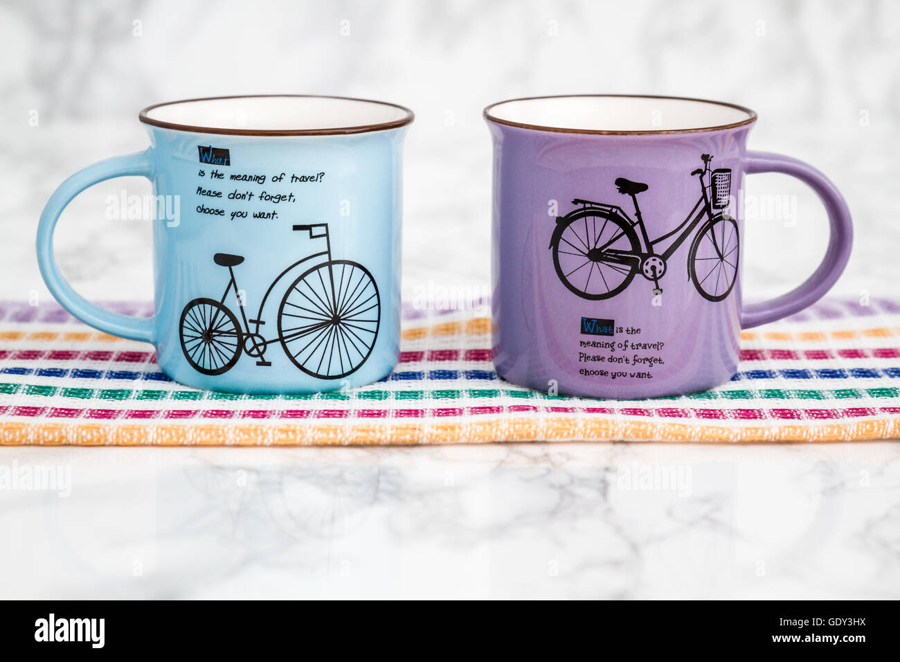 Colorful modern ceramic mugs with bicycle design on white marble ...