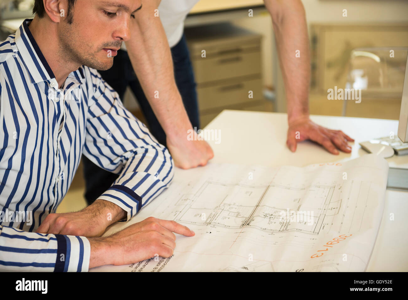 Midsection two engineers working blueprint hi-res stock photography and ...