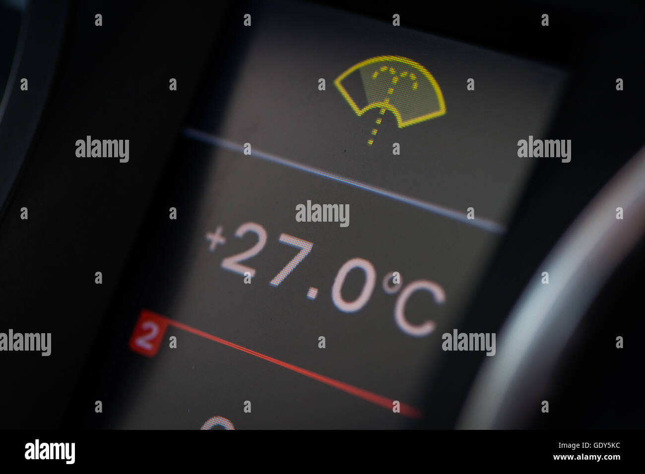 Close-up shot of a car's dashboard, with the wind screen washer icon ...