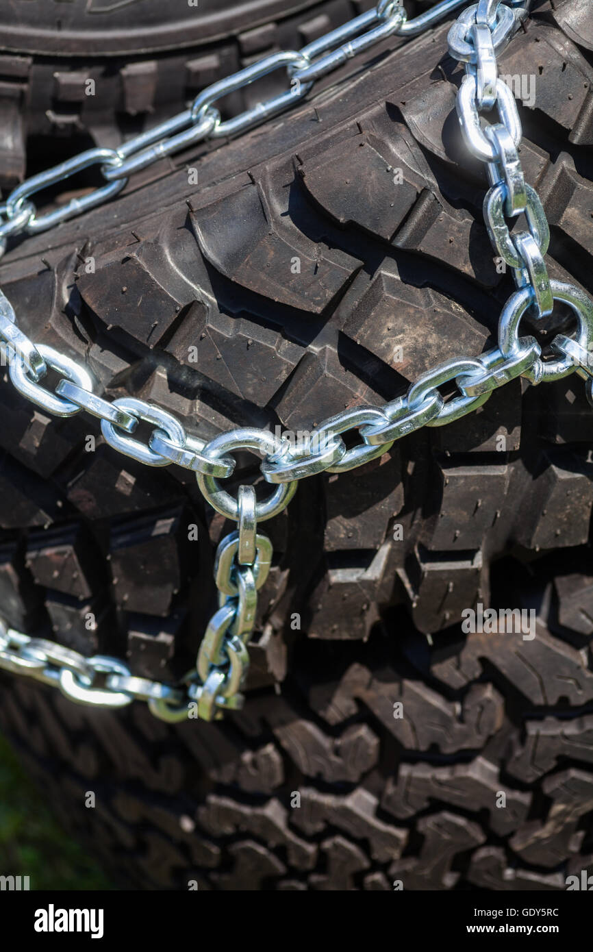Close up shot of some chains wrapped around a car's tire Stock Photo ...