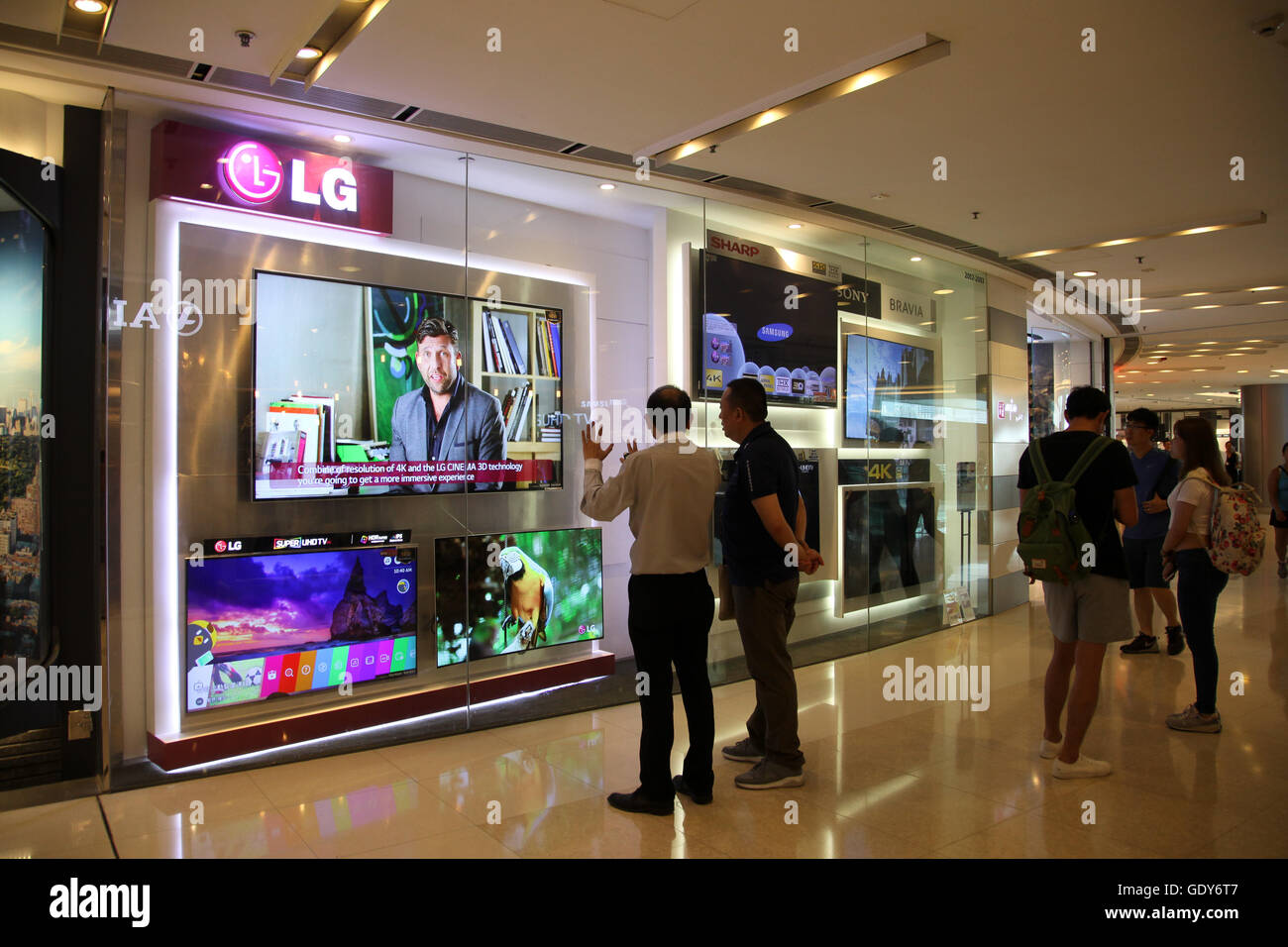 People looking at LG TVs in LG shop in IFC shopping mall central Hong Kong, Chain, Asia Stock ...