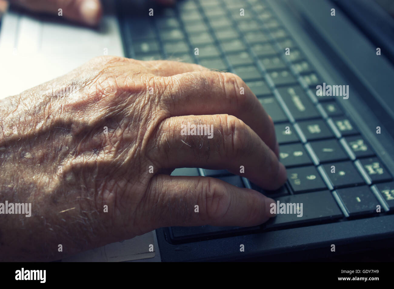 Old man using notebook Stock Photo - Alamy