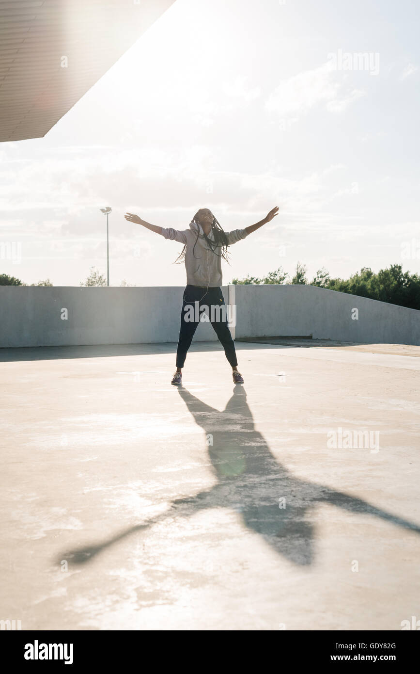 Beautiful African-American woman jumping and dancing with excitement on ...