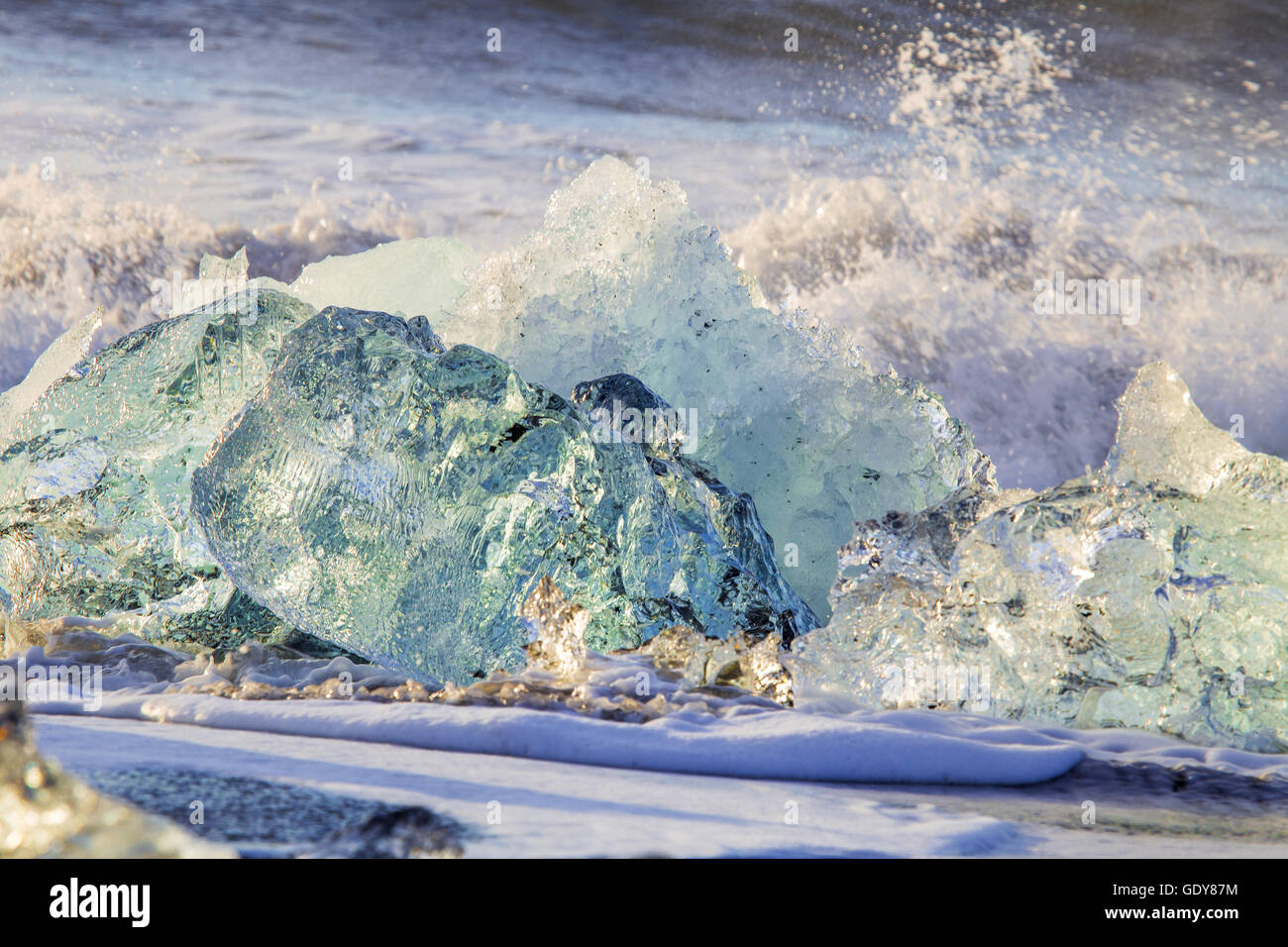 Green blue ice chunks melting on the beach by the glacial lagoon in ...