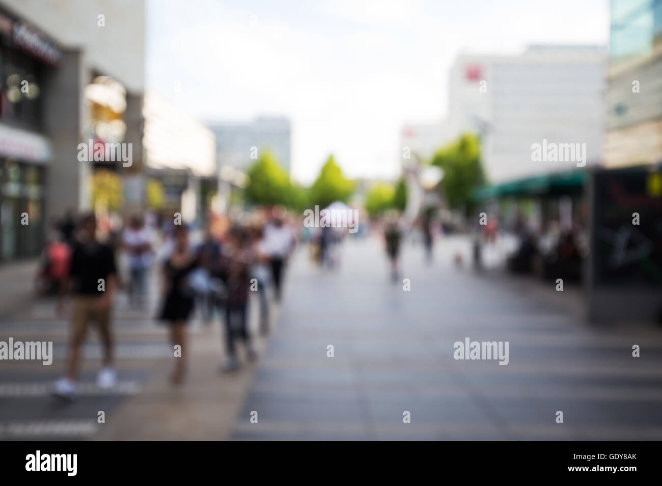 Out of focus shot of people walking on a shopping street in summertime ...