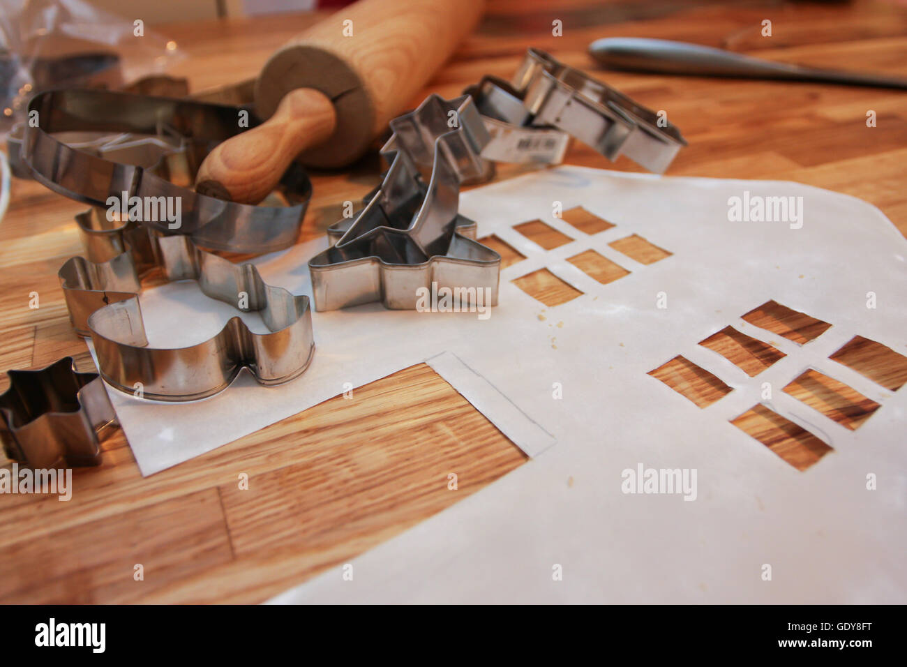 forms and designs for gingerbread cookies and house on a table ready ...