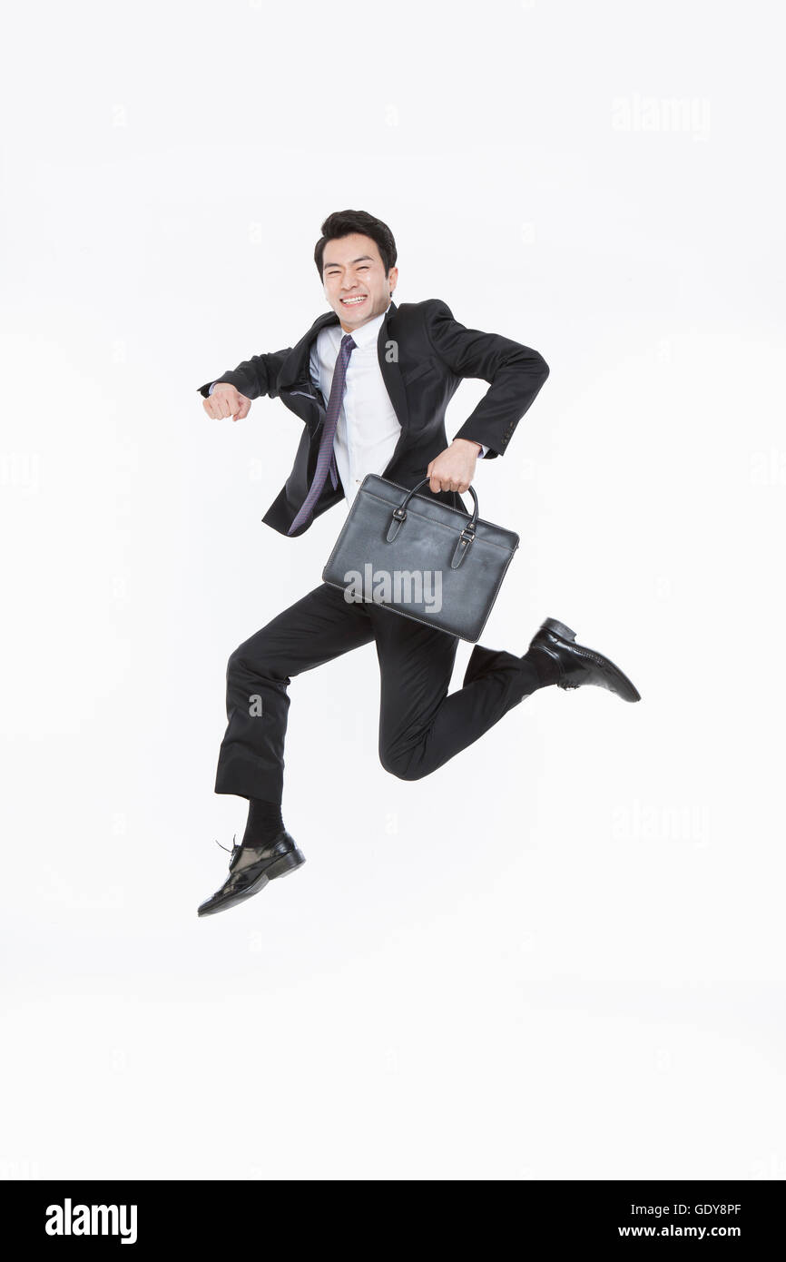 Smiling business man with a briefcase running Stock Photo - Alamy