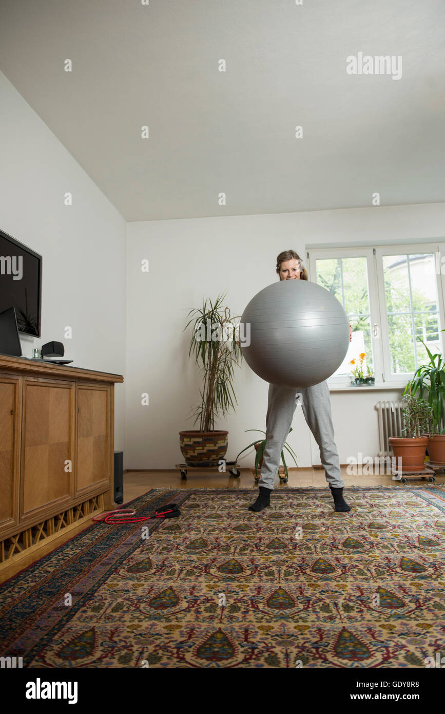 Woman carrying fitness ball hi-res stock photography and images - Alamy
