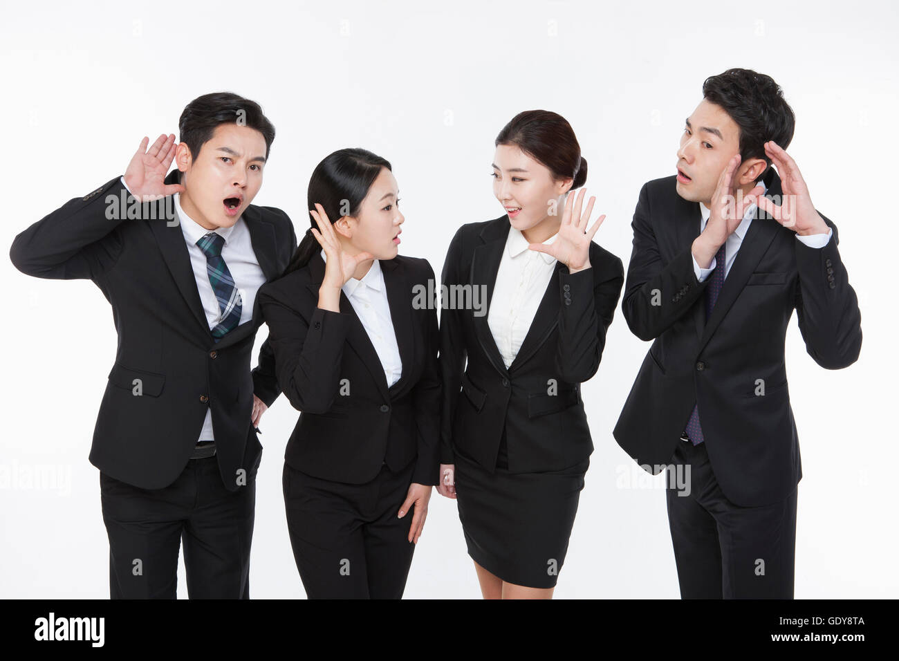 Four business people posing to listen well Stock Photo - Alamy