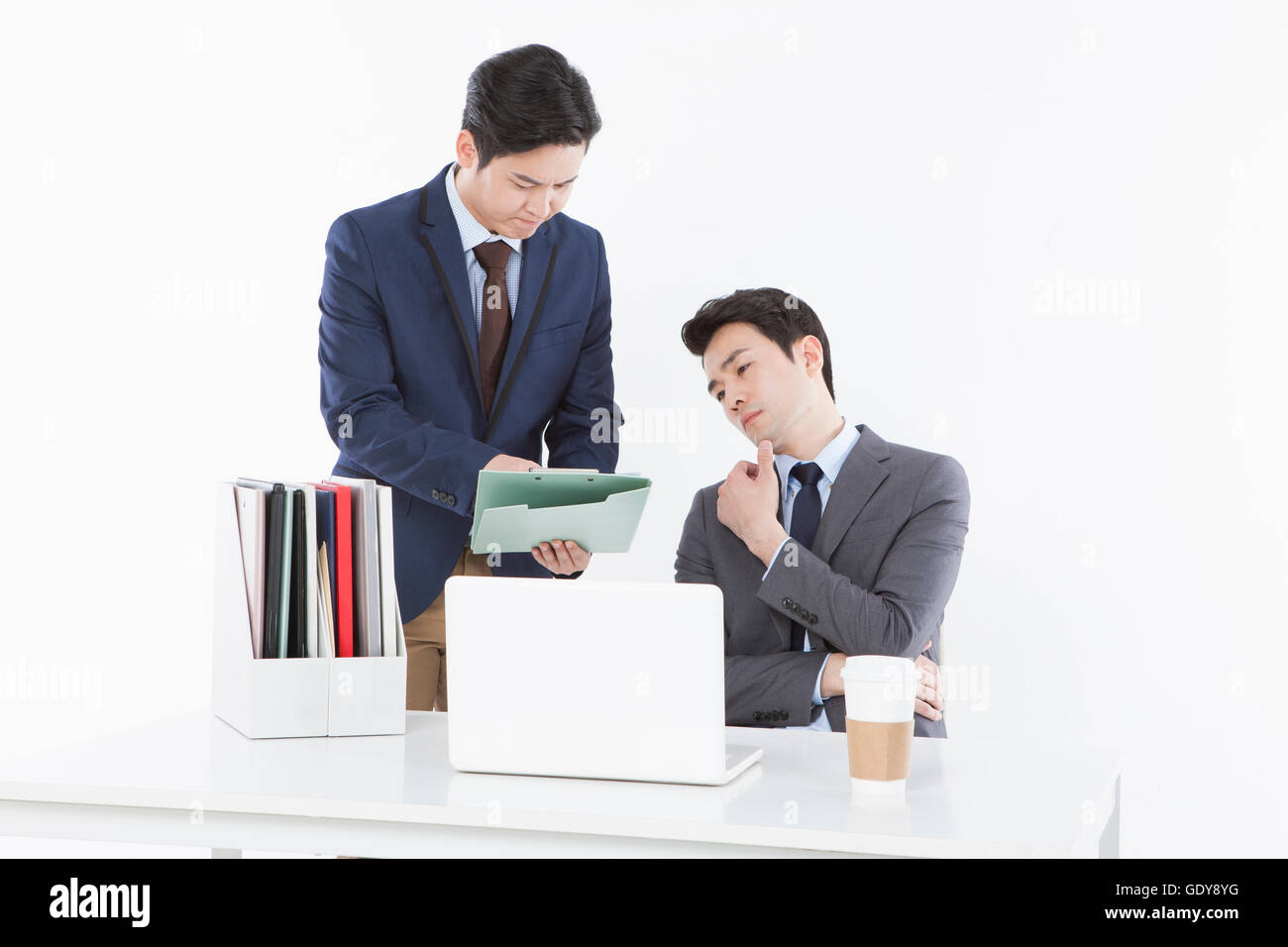 Business man showing files ro his superior at work Stock Photo - Alamy