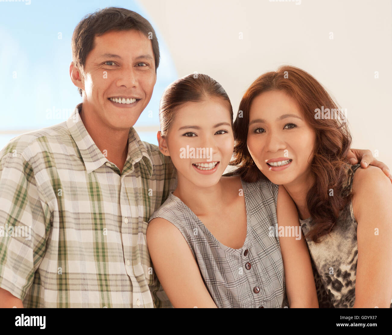 A happy Asian family smiling and posing for photographing Stock Photo ...