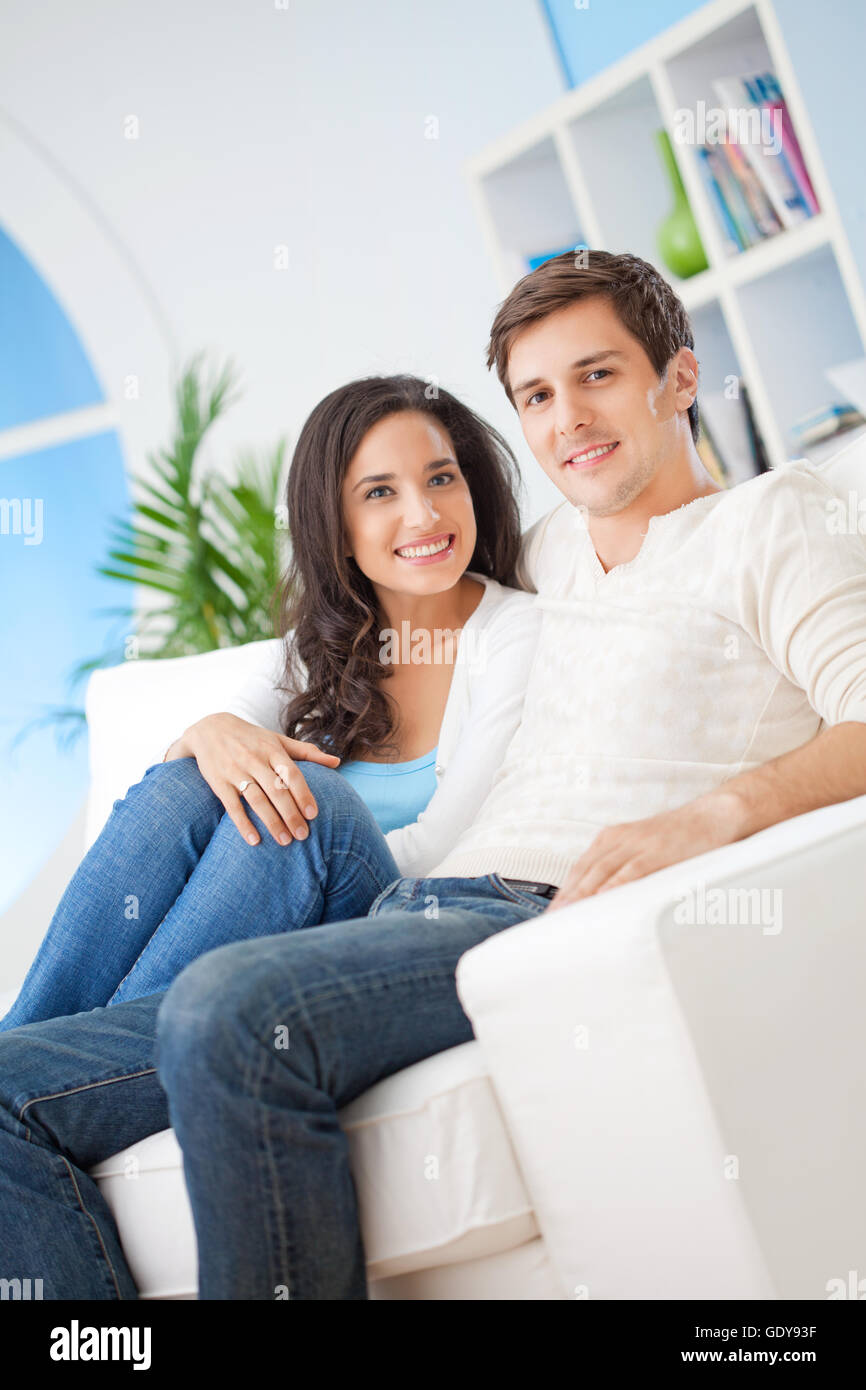 Happy young couple in their modern living room Stock Photo - Alamy