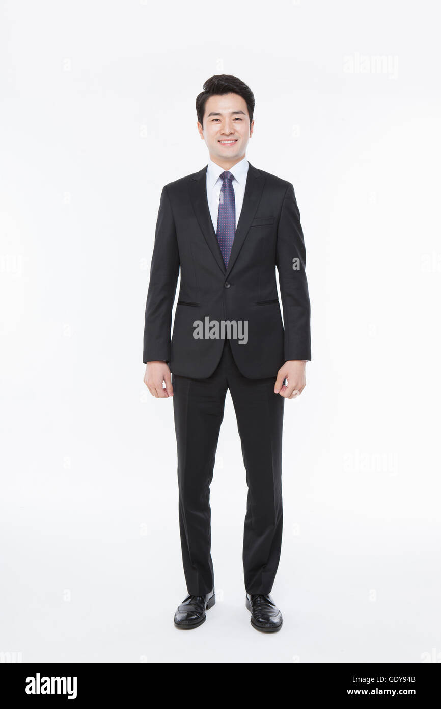 Smiling business man in suit standing Stock Photo - Alamy