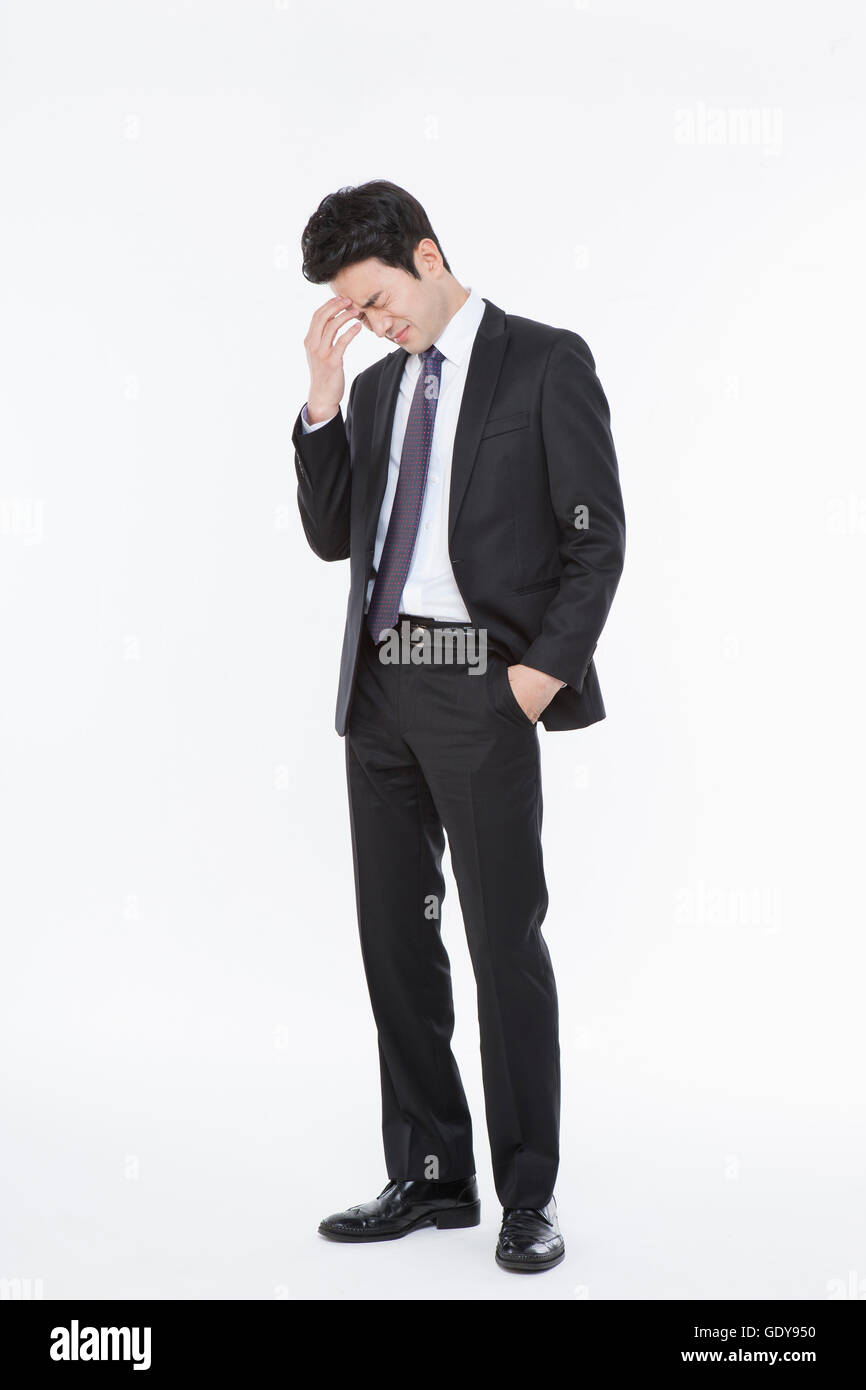 Stressful business man in suit standing Stock Photo - Alamy