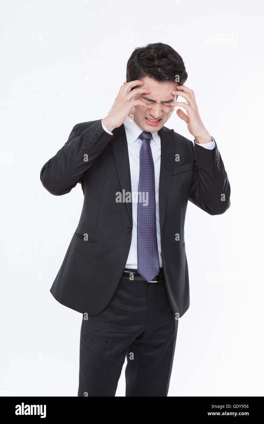 Stressful business man having a headache Stock Photo - Alamy