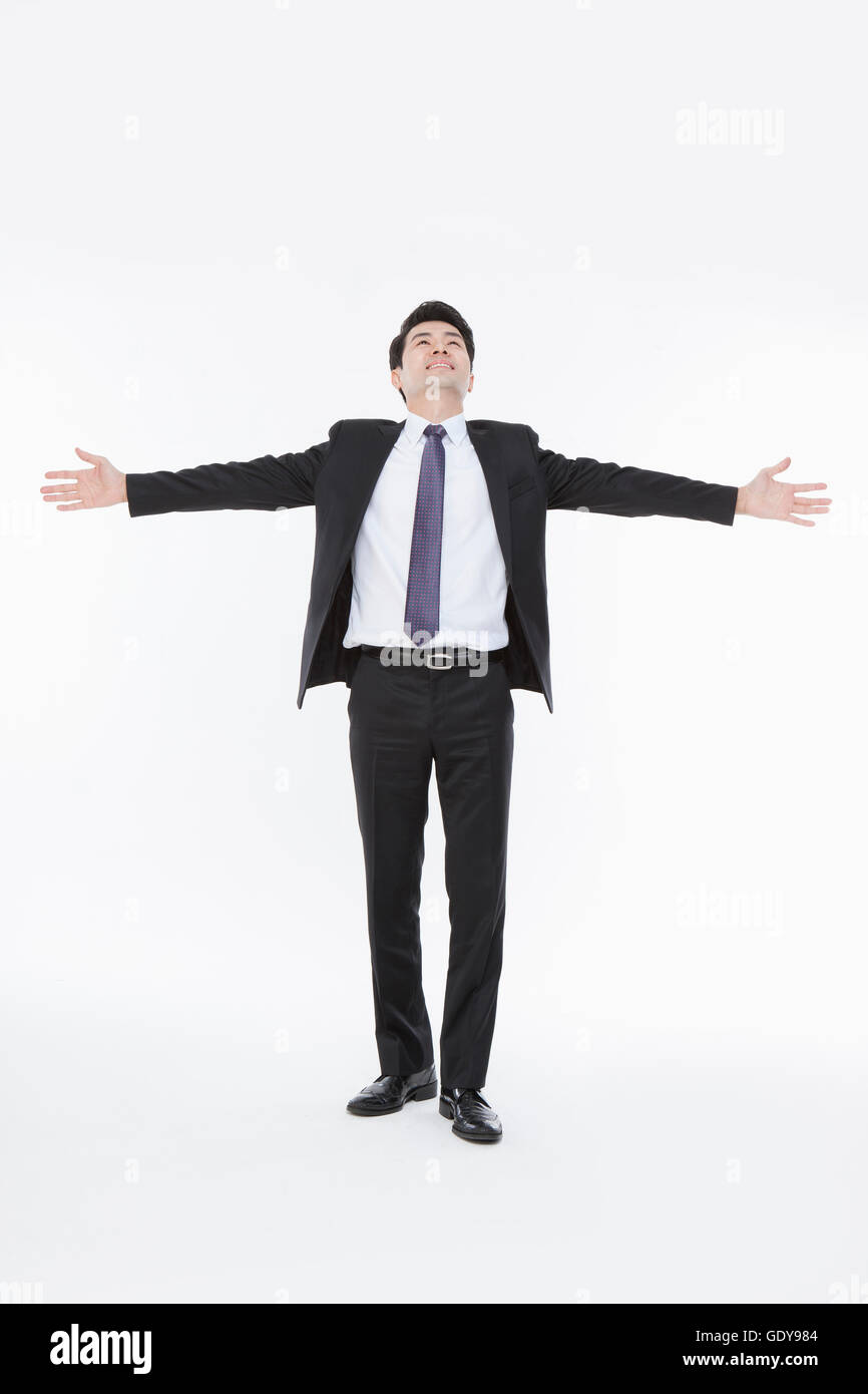 Smiling business man standing opening his arms looking up Stock Photo ...