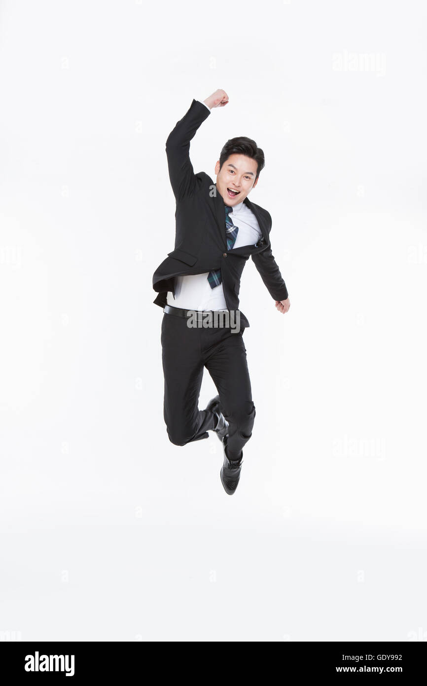 Business man in suit jumping into the air Stock Photo - Alamy