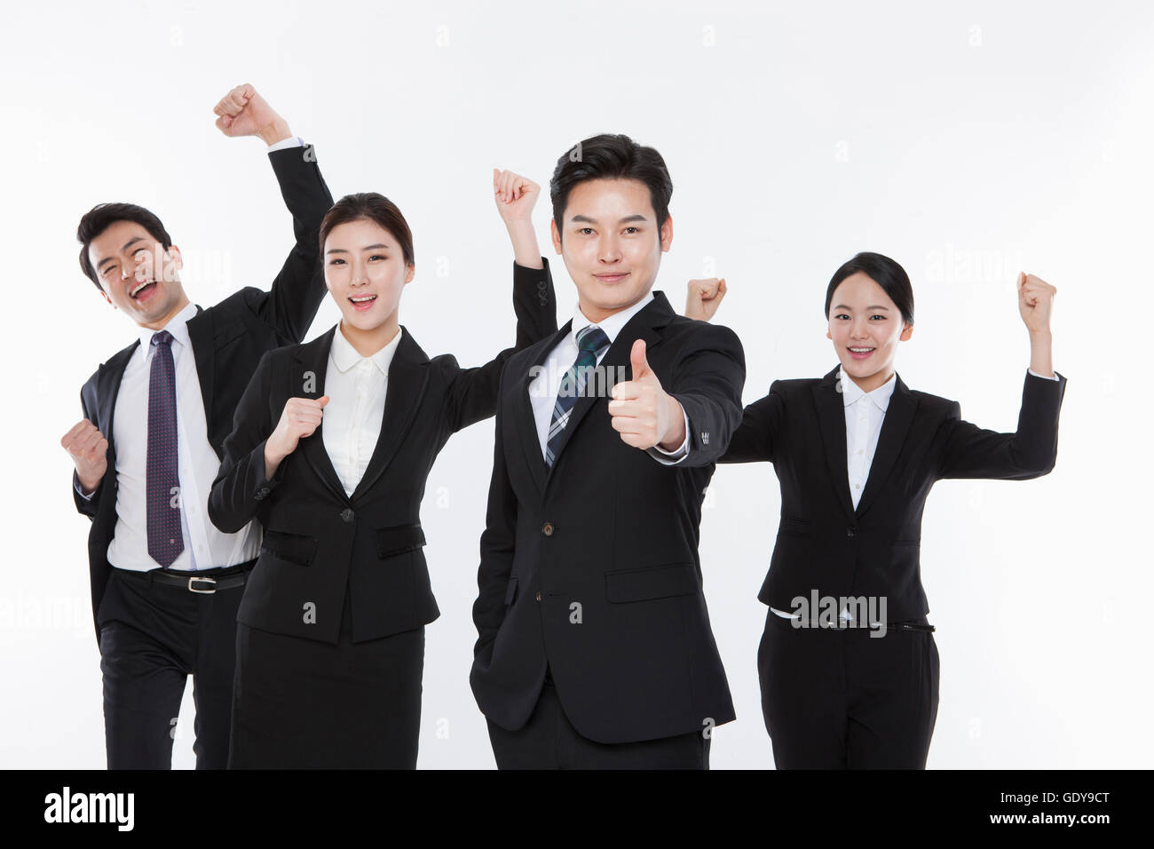 Four smiling business people in suits cheering up Stock Photo - Alamy
