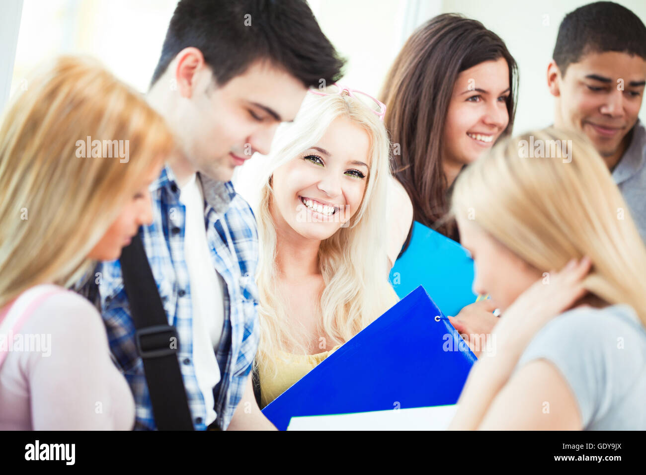 Group of happy college students standing together in the hallway Stock ...