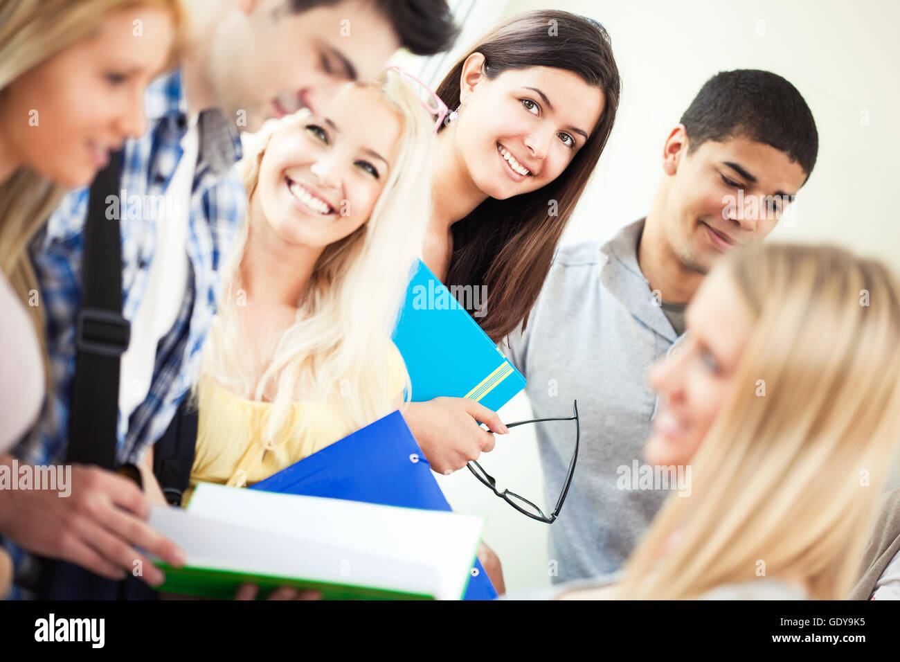 Group of smiling university students standing together Stock Photo - Alamy