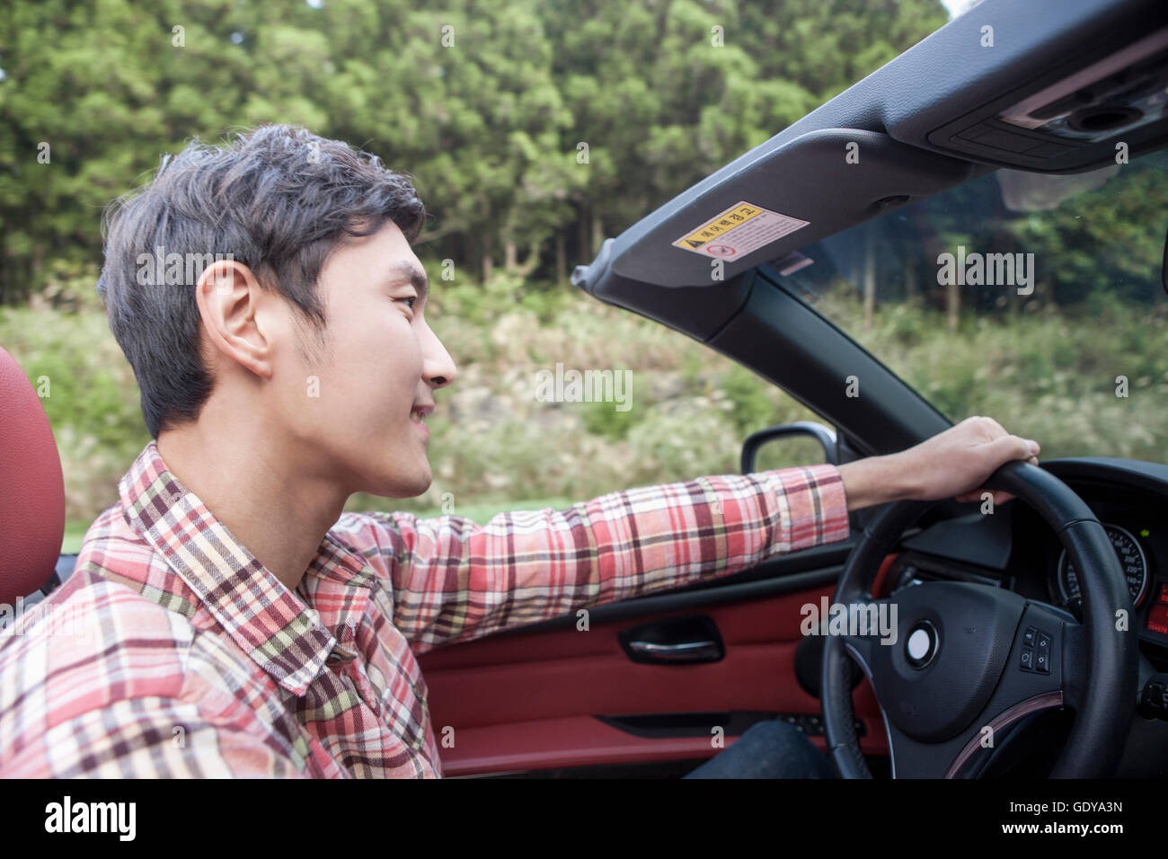 Side view portrait of young smiling male driver Stock Photo - Alamy
