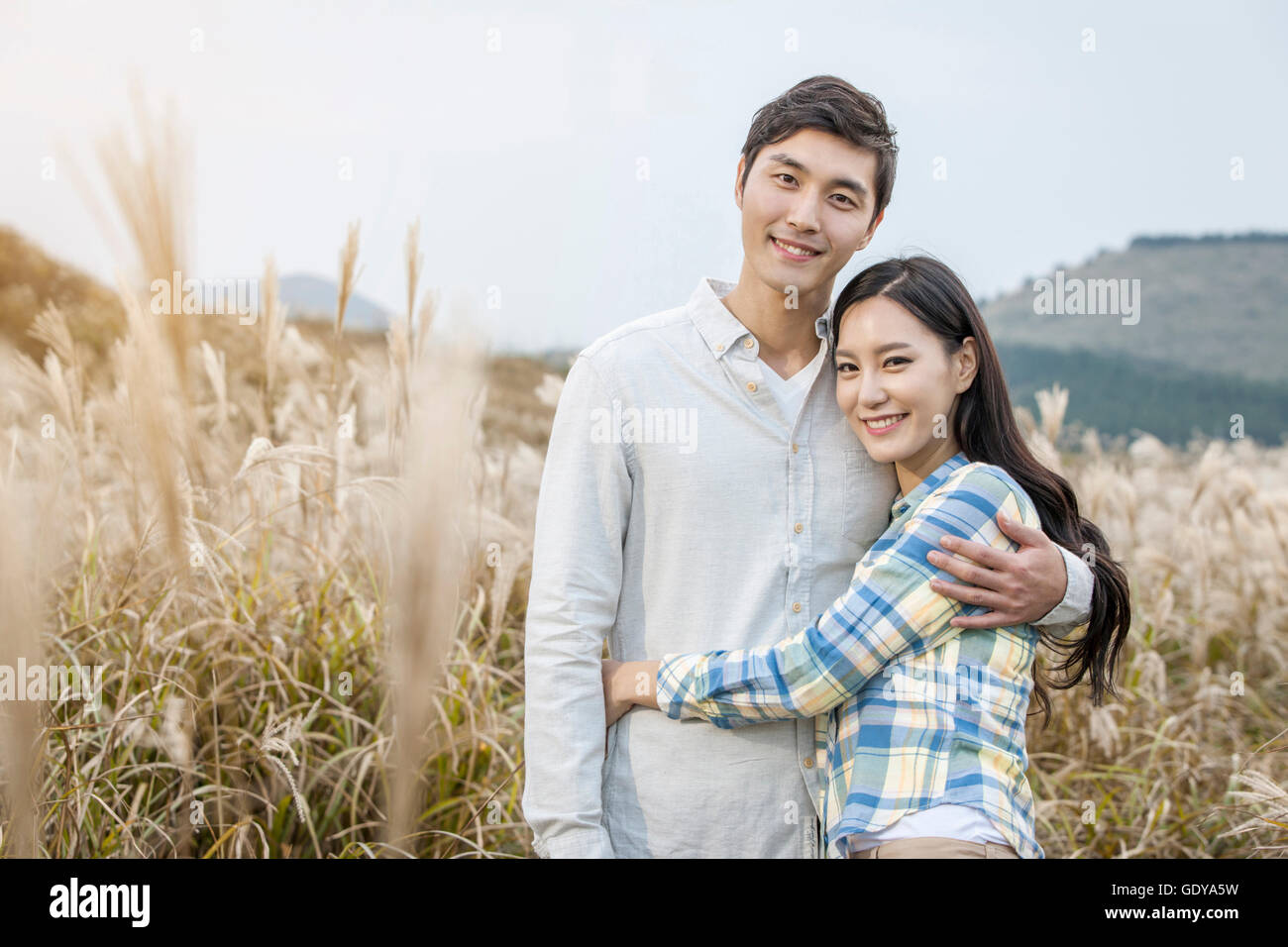 Couple hugging in field hi-res stock photography and images - Alamy