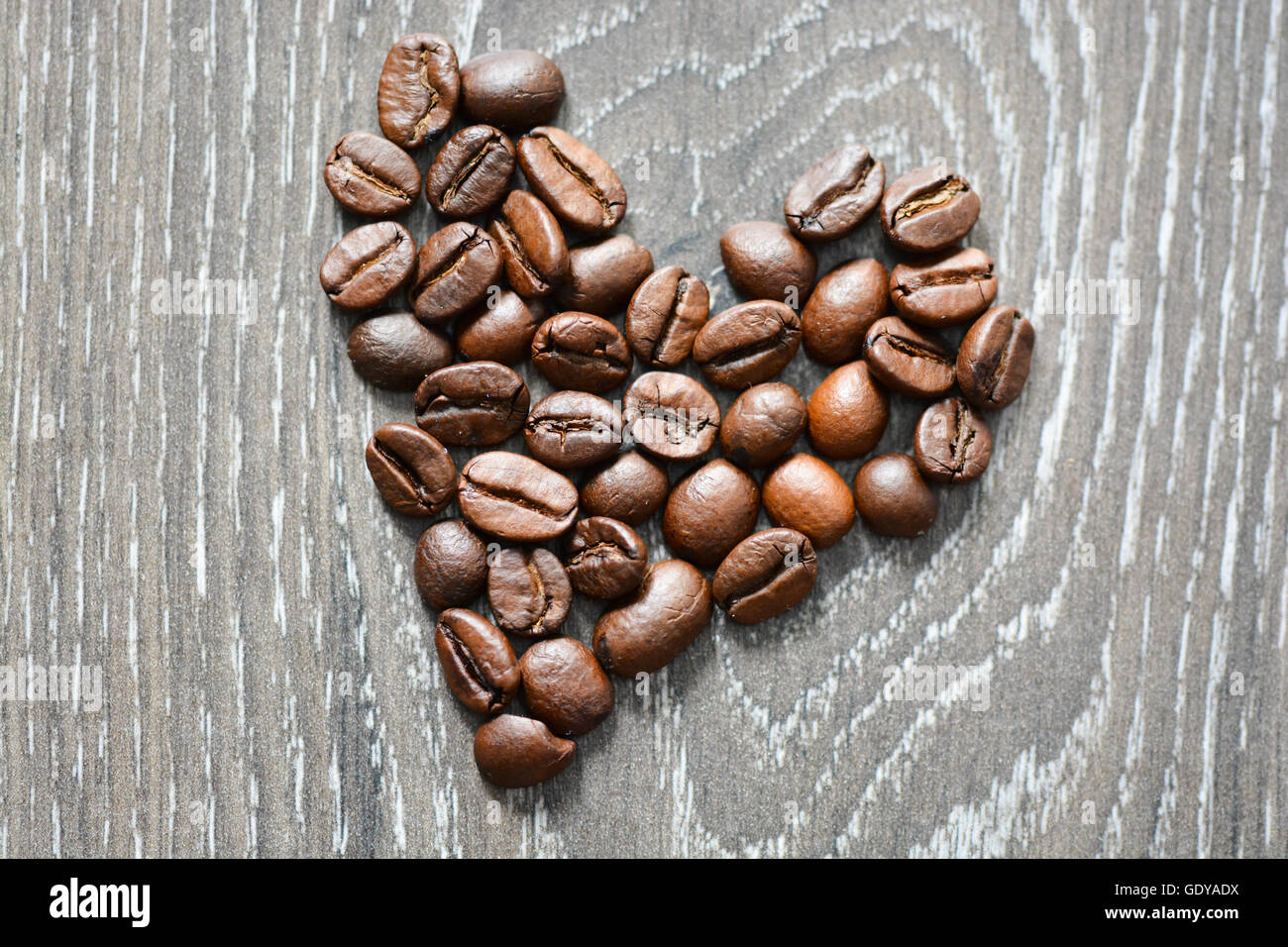 Heart shaped coffee beans suggesting coffee addiction Stock Photo - Alamy
