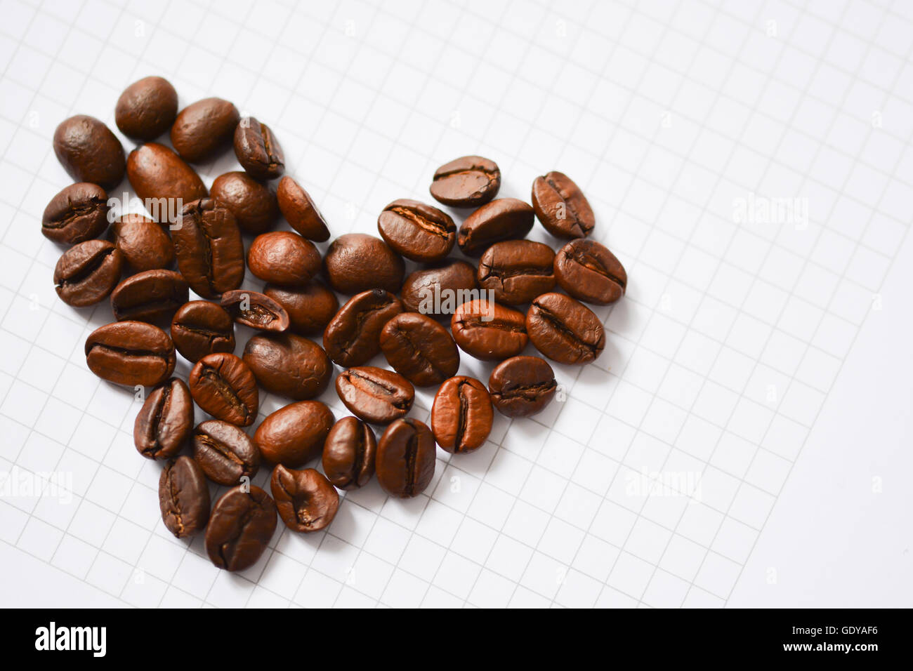 Heart shaped coffee beans suggesting coffee addiction Stock Photo - Alamy