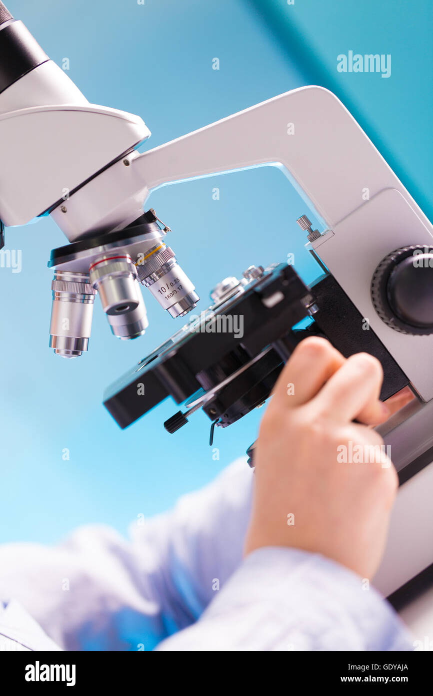 Scientist young woman using a microscope in a science laboratory Stock ...