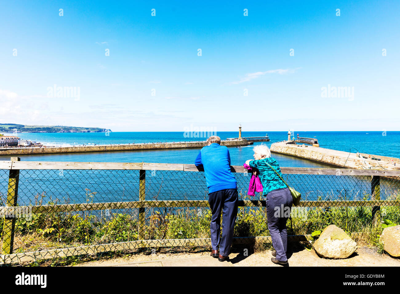 Old people reminiscing looking out to sea remembering better times past ...
