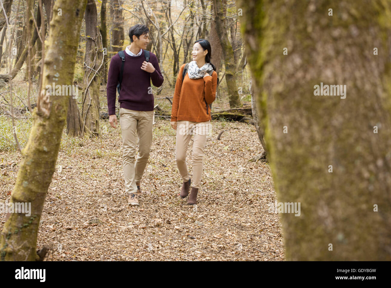 Young smiling couple trekkers walking in forest face to face Stock ...