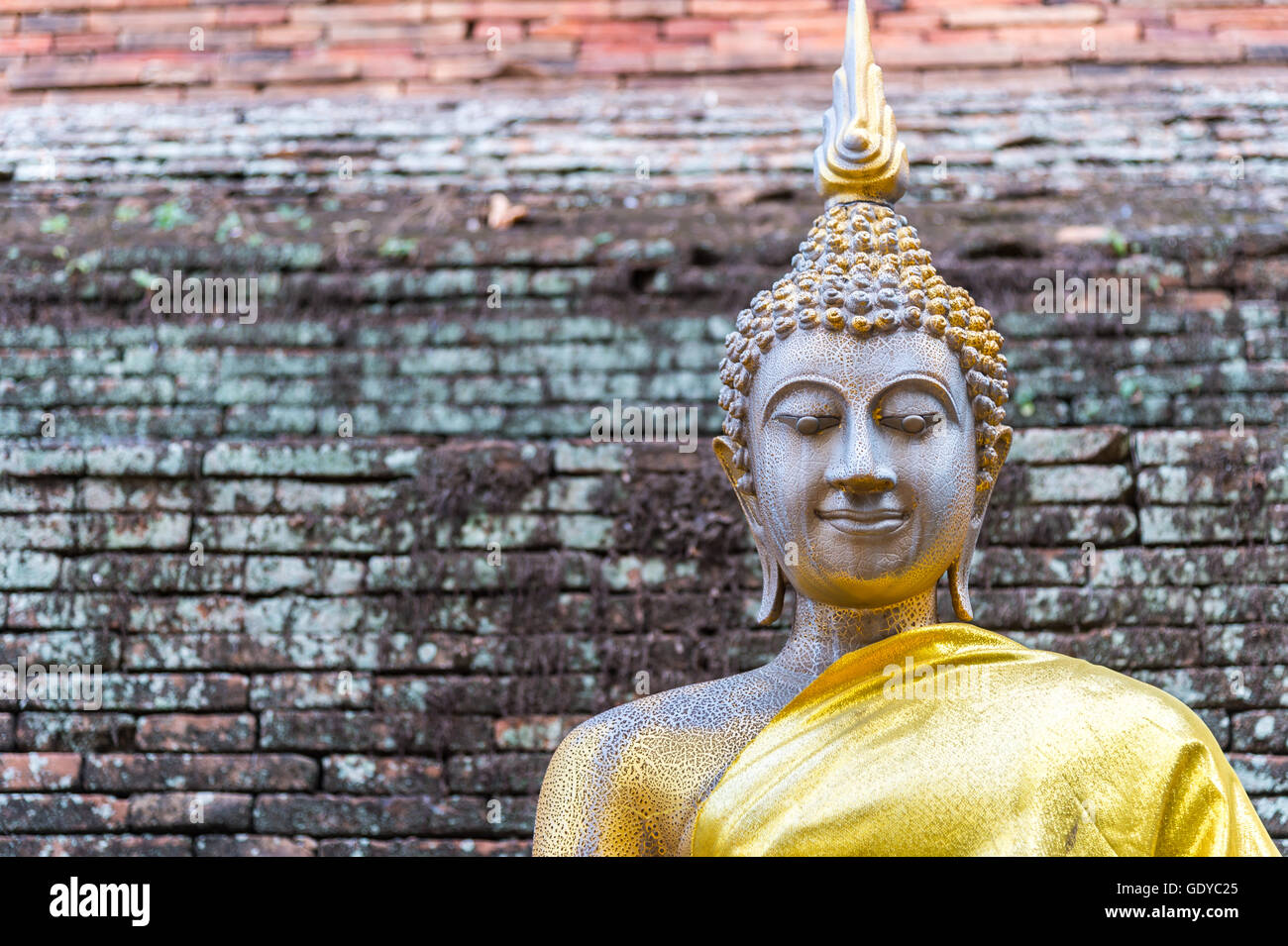 Old Buddha statue with brick wall background Stock Photo - Alamy