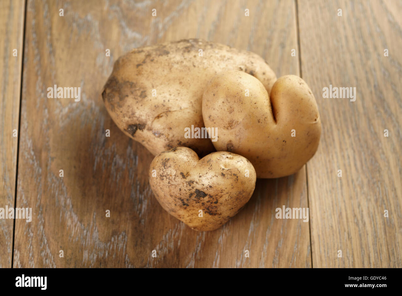 heart shaped potatoes on oak table Stock Photo - Alamy