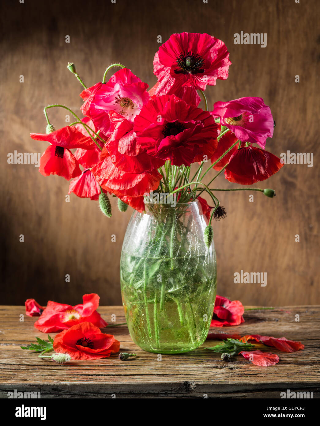 Bouquet of poppy flowers in the vase on the wooden table Stock Photo ...