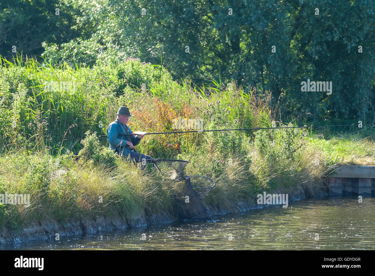 Man fishing on the Norfolk Broads Stock Photo - Alamy