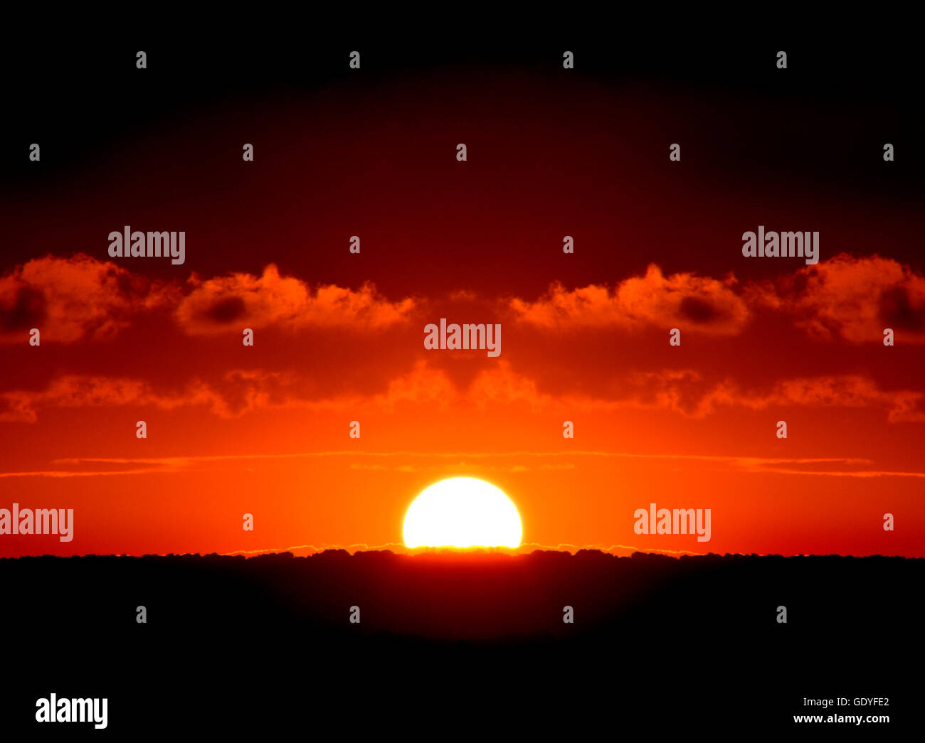 Symmetrical sunset (original image reflected digitally Stock Photo - Alamy