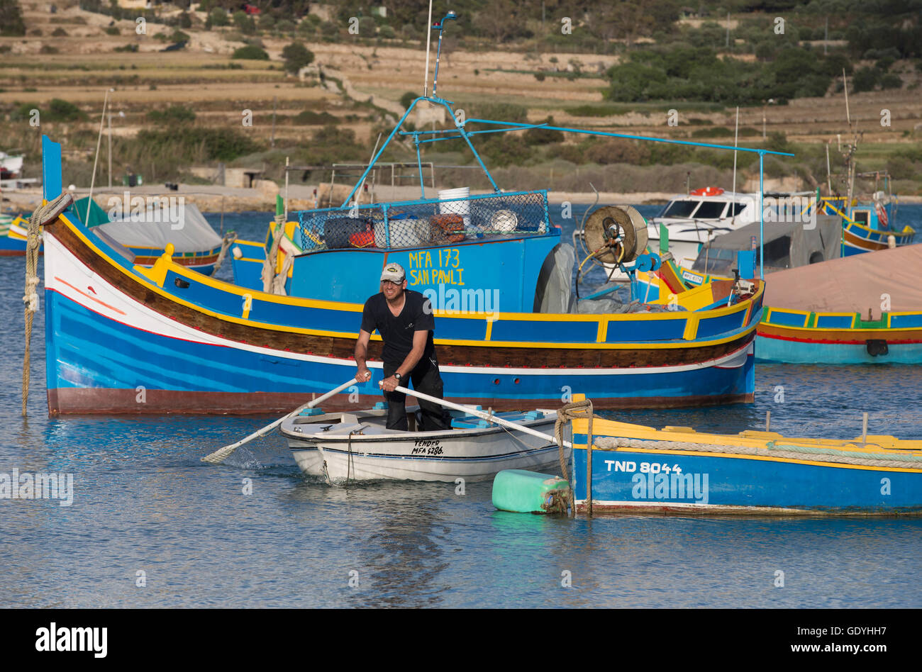 Colorfully painted boats, so-called Luzzu, in the harbor of the fishing ...