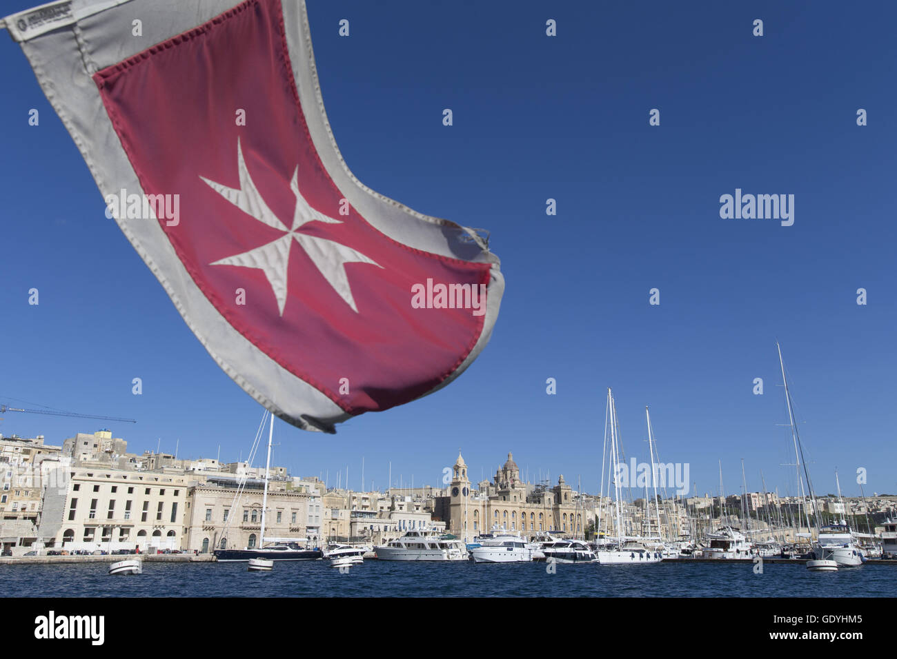 Malta's merchant flag and the St. Angelo harbor of Vittoriosa in the ...