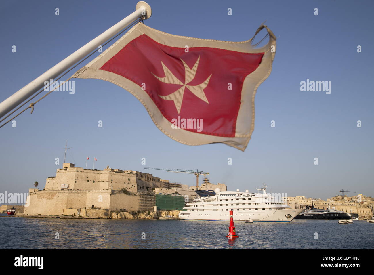 Malta's merchant flag and the St. Angelo harbor of Vittoriosa in the ...