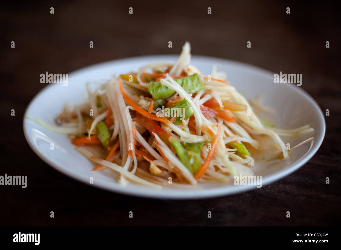 Fresh made hot papaya salad Som Tam with bean, carrot and peanuts ...