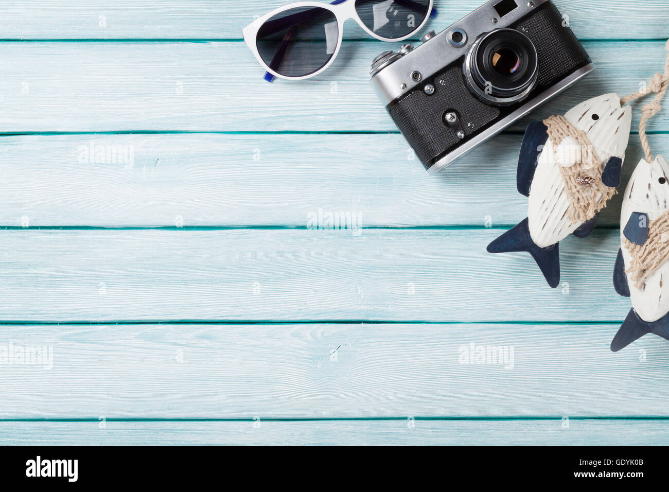 Beach accessories backdrop. Camera and sunglasses on wooden background ...