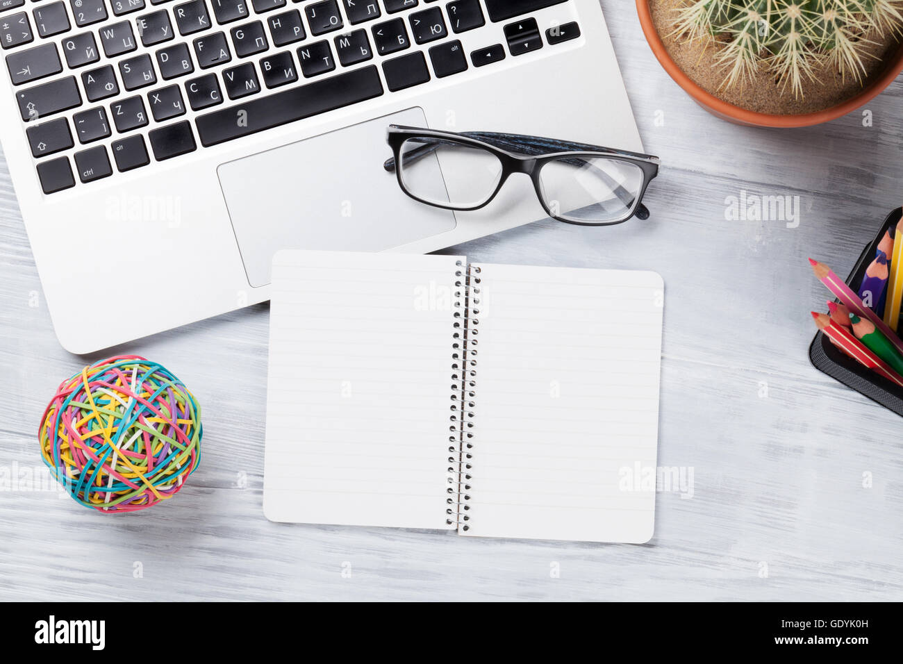 Desk table with laptop and notepad on wooden table. Workplace. Top view ...
