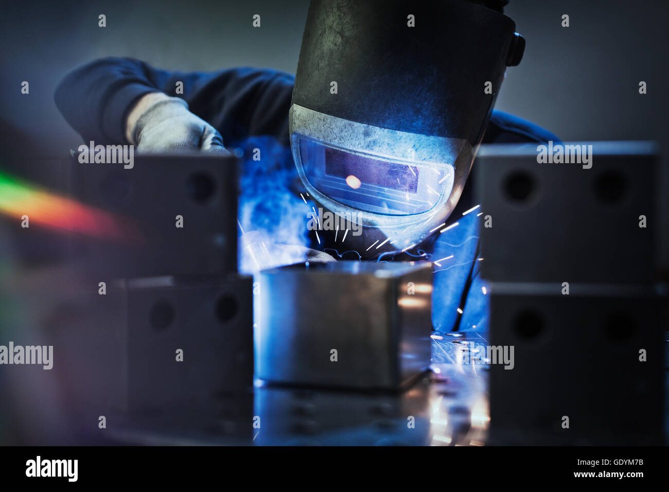 Welder using welding torch on part in steel factory Stock Photo - Alamy