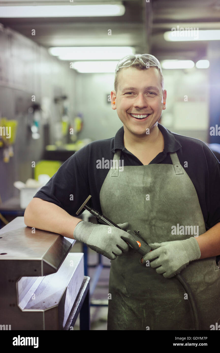 Portrait smiling worker in steel factory Stock Photo - Alamy